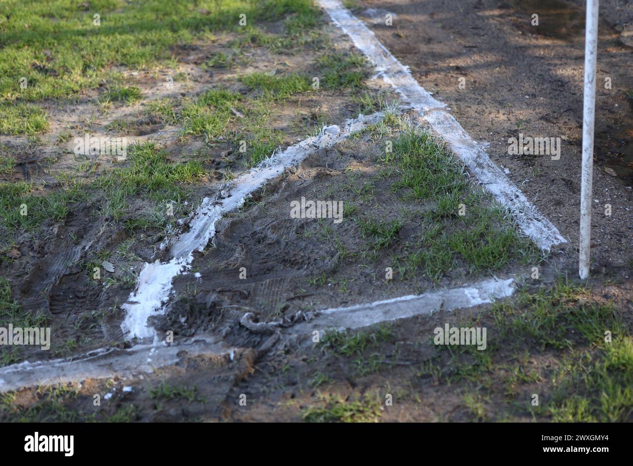 Corner quadrant of football pitch showing pitch markings and mud muddy ...