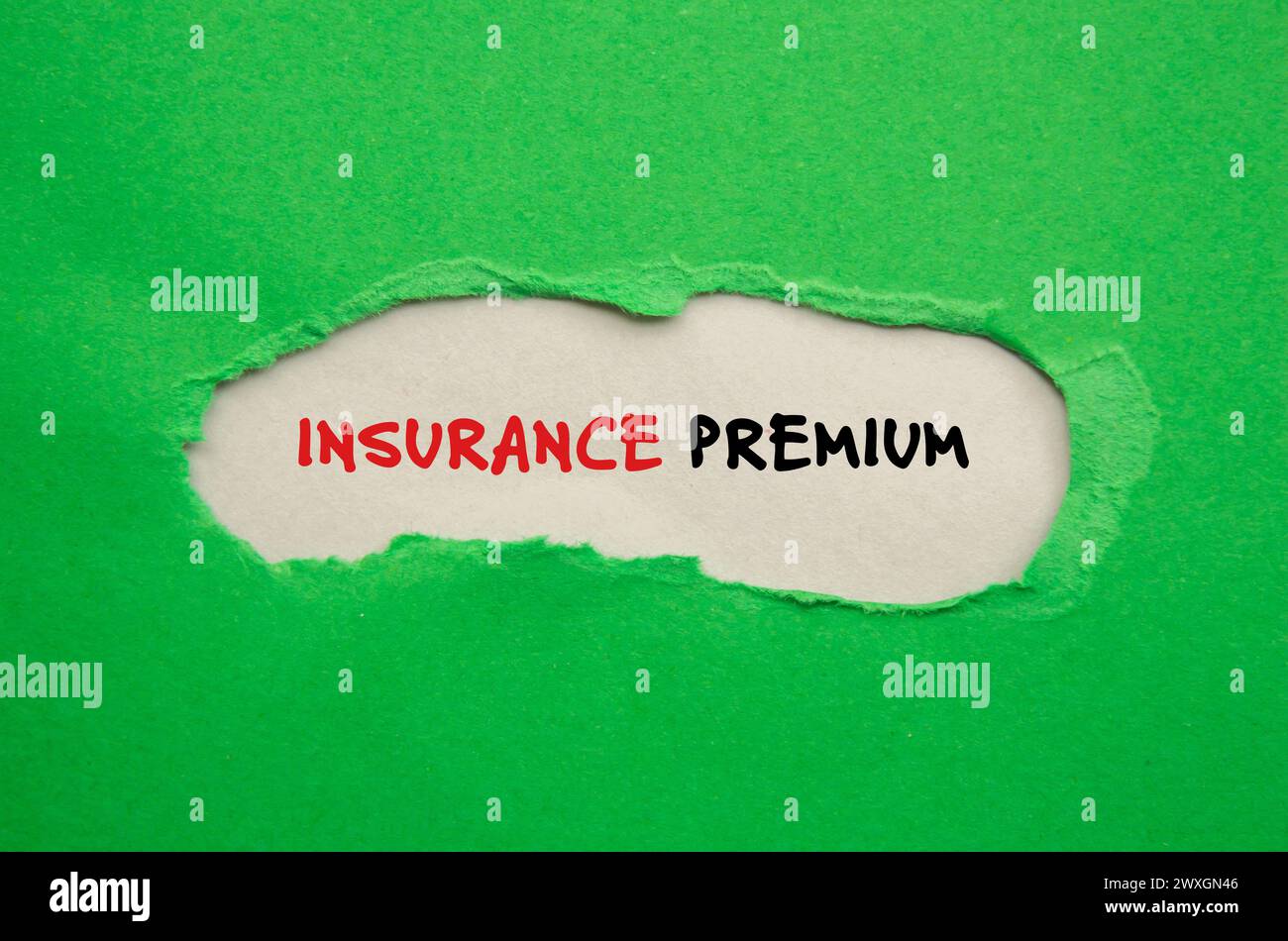 Insurance premium words written on green torn paper with gray ...