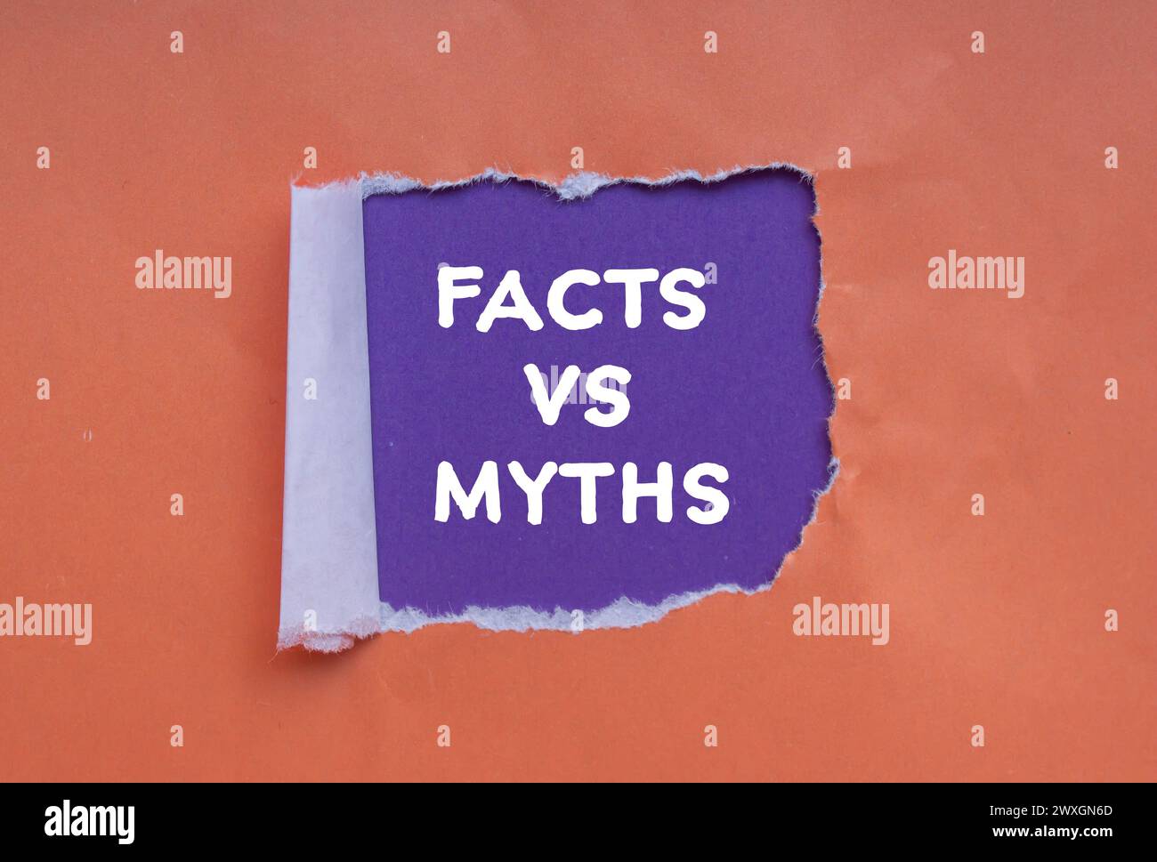 Facts vs myths words written on orange torn paper with purple ... Facts vs myths words written on orange torn paper with purple ...