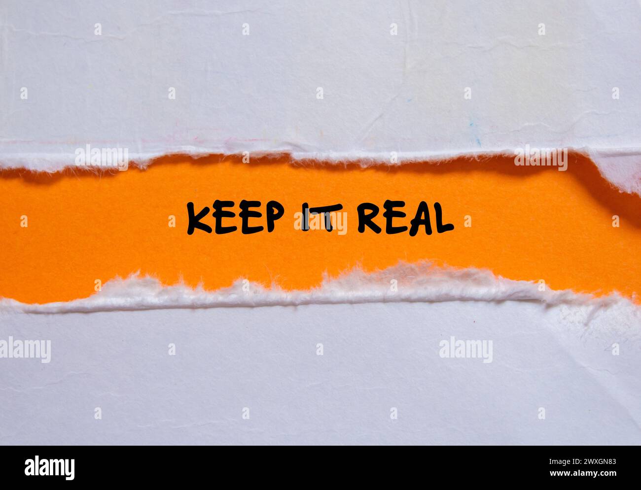 Keep it real words written on torn paper with orange background ...