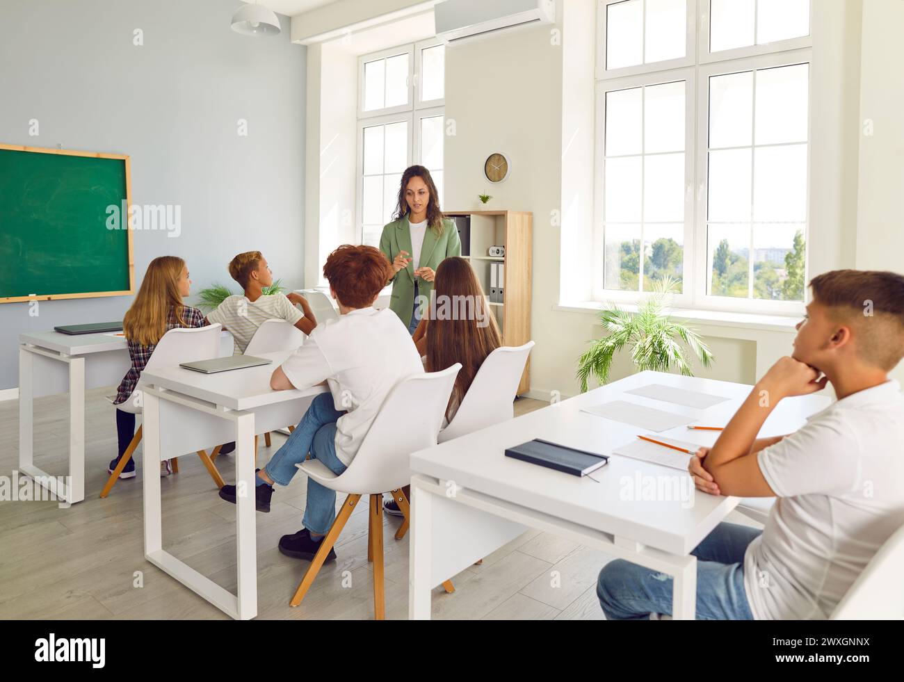 Teacher Leading Students in Engaging Lesson Stock Photo - Alamy