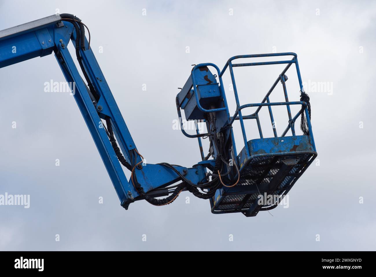 Extendable cherry picker with hydraulic arm and close up on cradle with ...