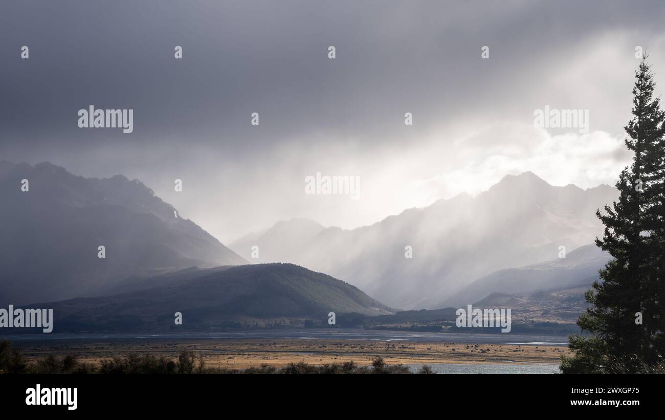 Storm with dark thick clouds raging above alpine landscape with ...