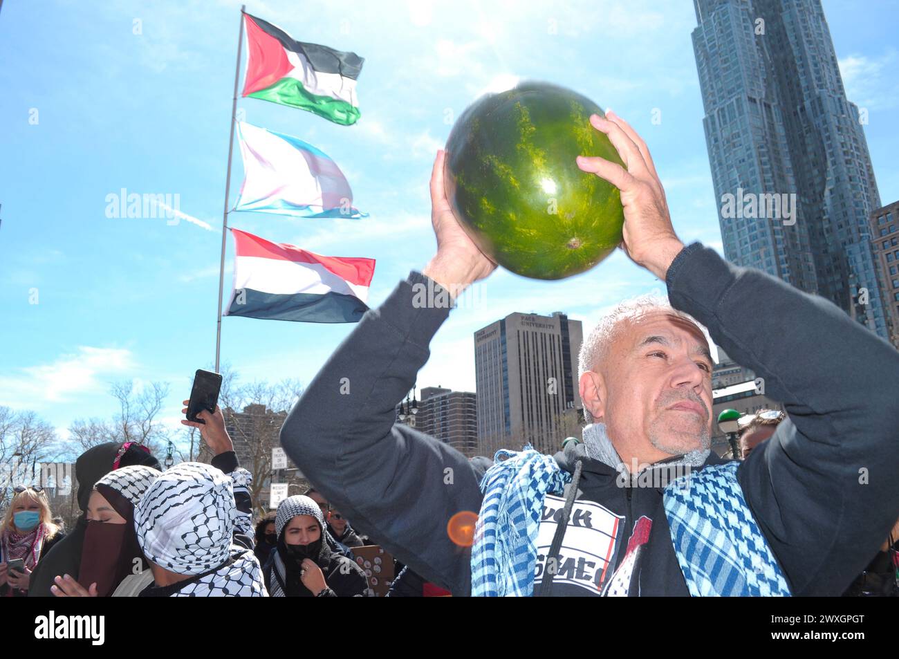A pro-Palestine demonstrator holds up a watermelon, symbolizing the ...