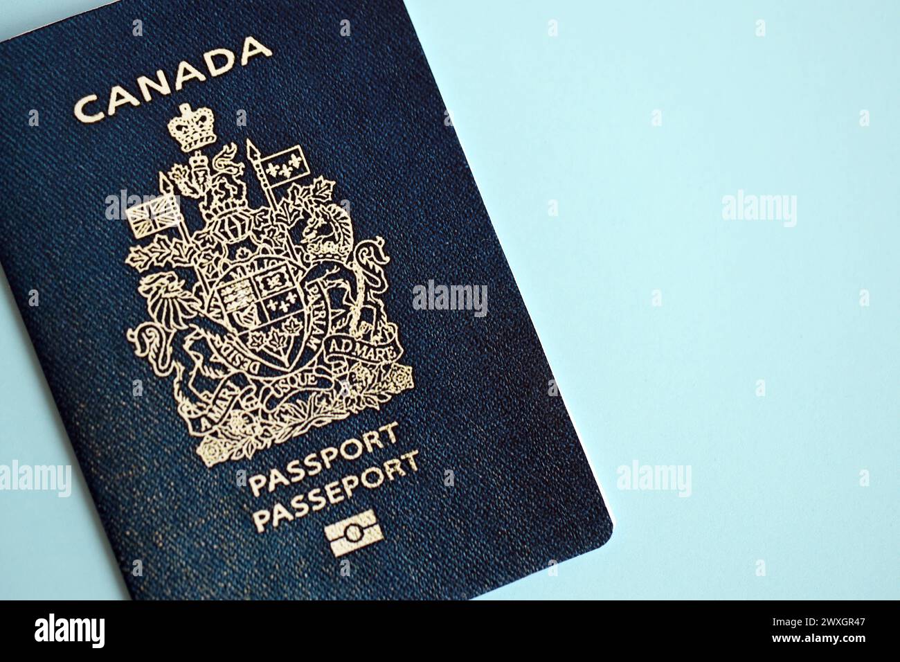 Canadian passport on blue background close up. Tourism and citizenship ...