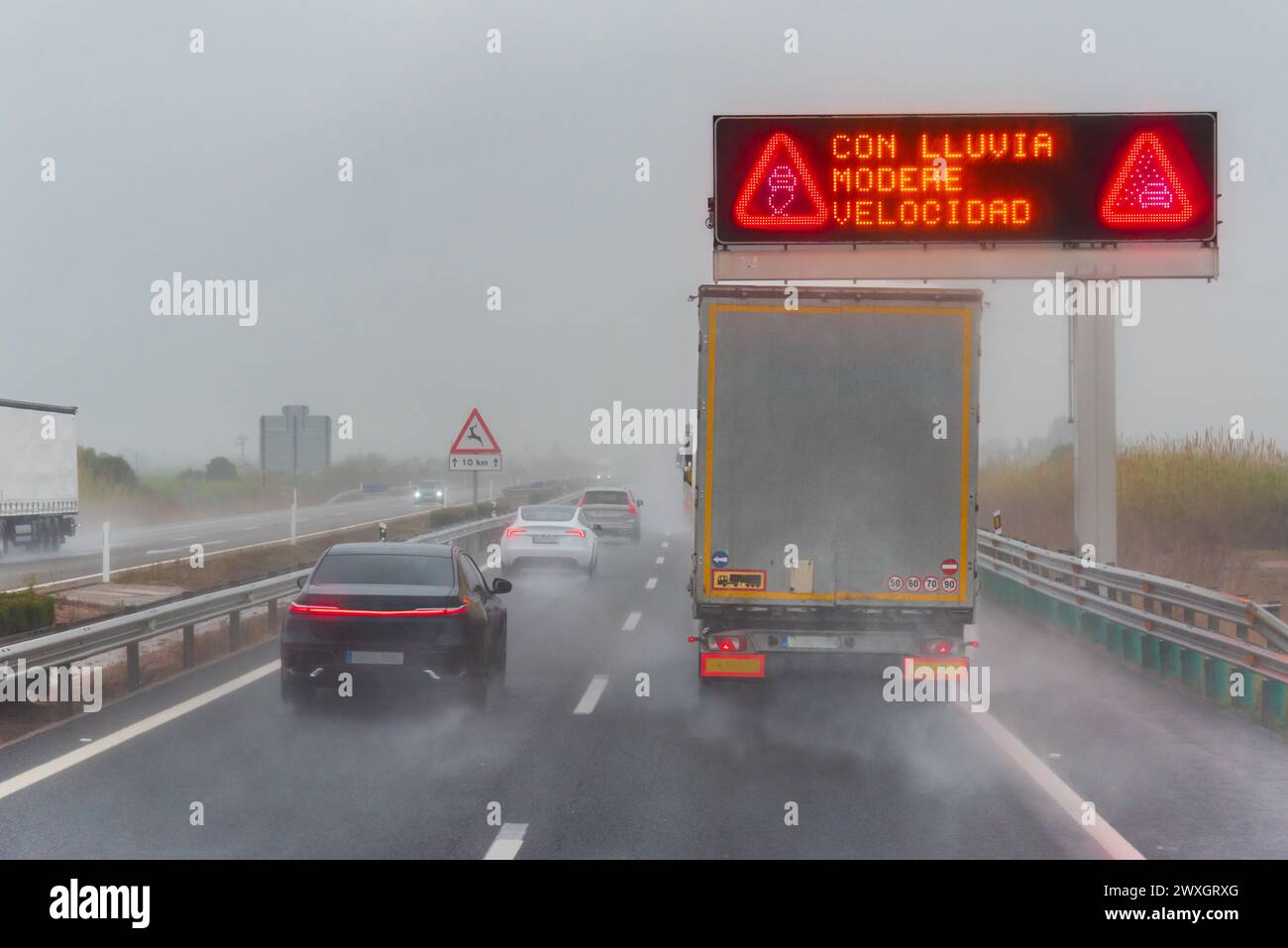 Illuminated panel on a highway with the legend in rain, moderate speed ...