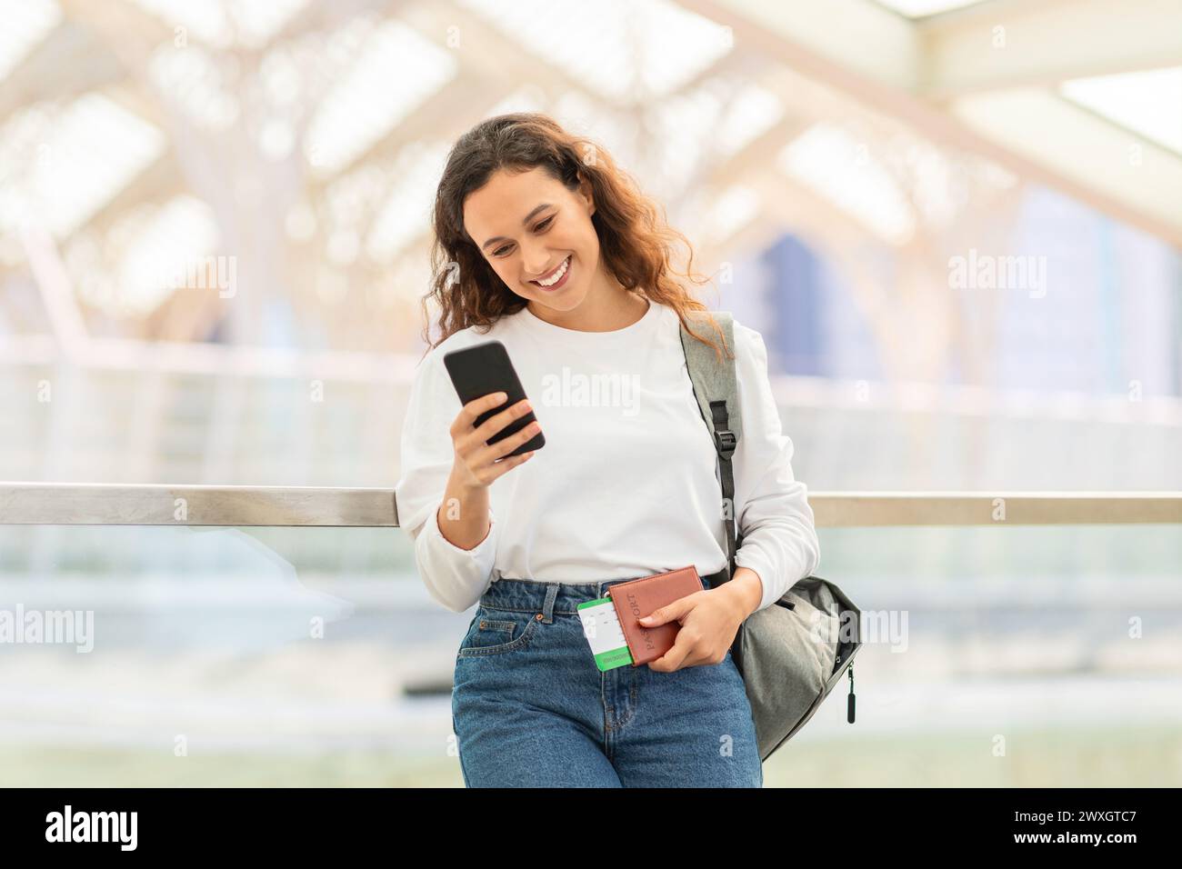 Woman engaged with mobile device Stock Photo - Alamy