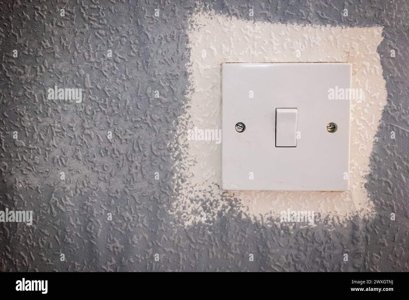 light switch on painted wallpaper wall texture closeup during home ...