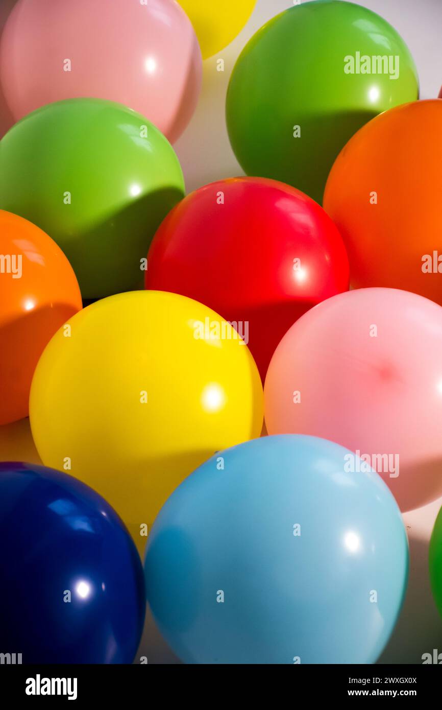 A vertical of colorful balloons grouped on white background Stock Photo ...