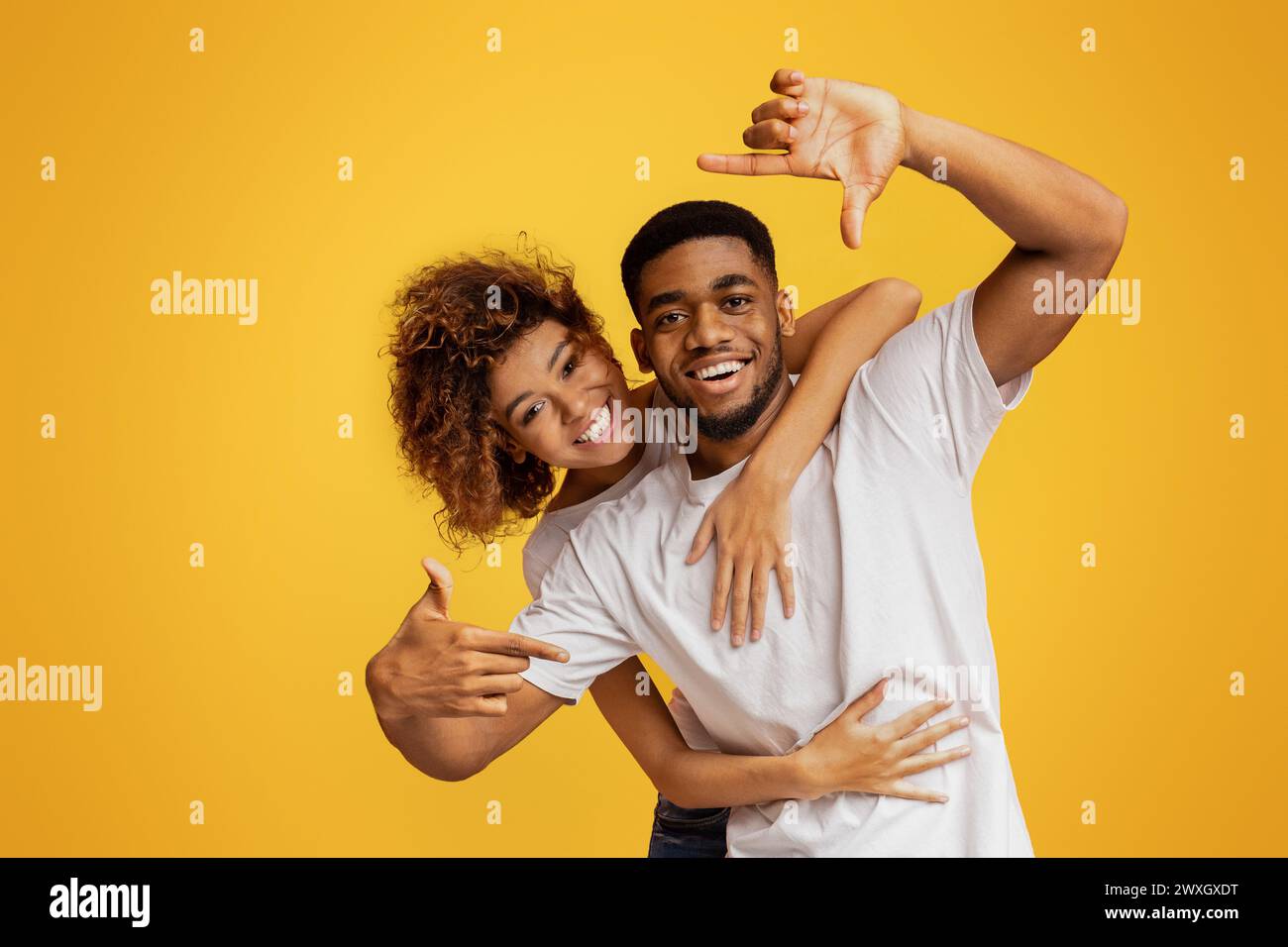 Couple having fun taking picture with imaginary camera Stock Photo - Alamy
