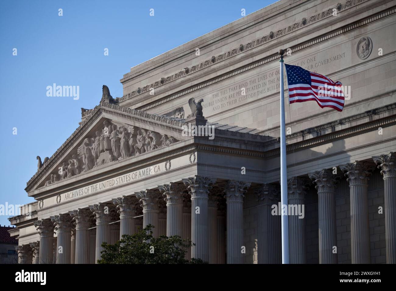 American flag waving in front of a National archives building ...