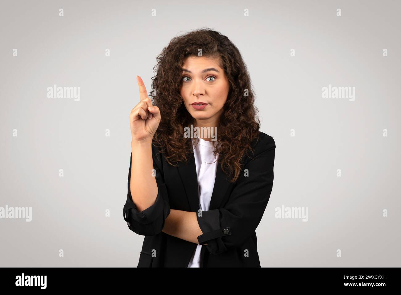 Woman with a warning finger raised Stock Photo - Alamy