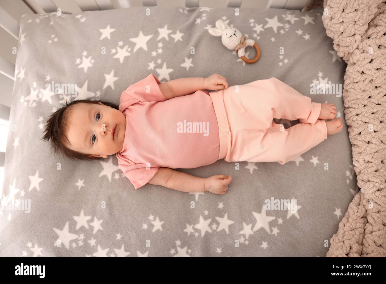 Time to sleep. Cute little baby lying in crib, top view Stock Photo - Alamy