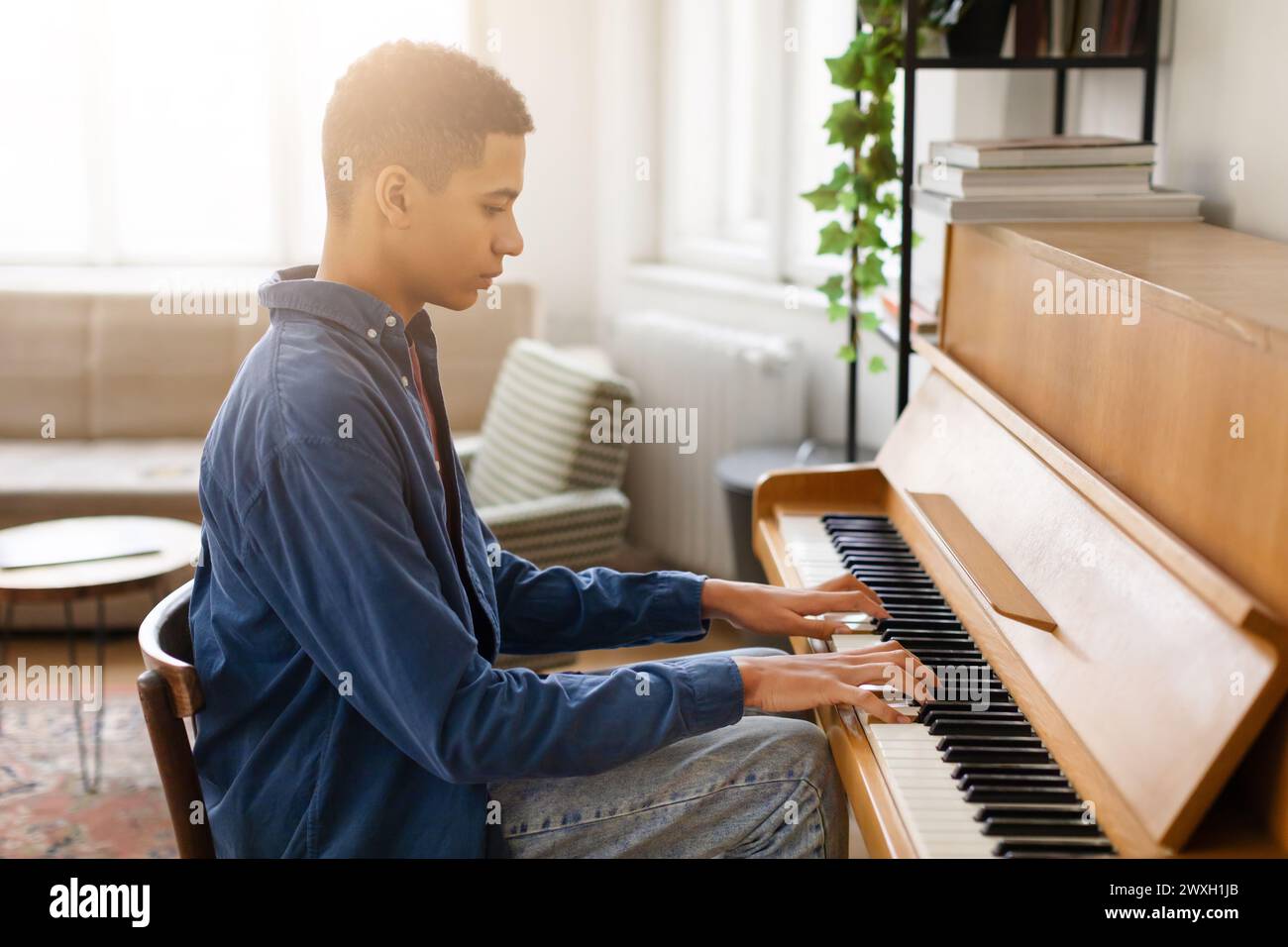 Young musician practicing piano in a peaceful room Stock Photo - Alamy