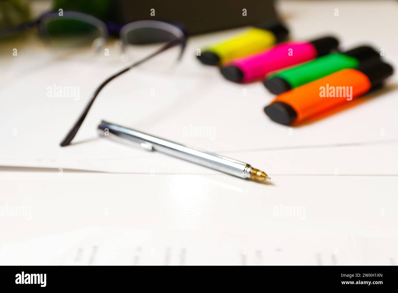 Collection of silver pen and colorful markers elegantly arranged on a ...