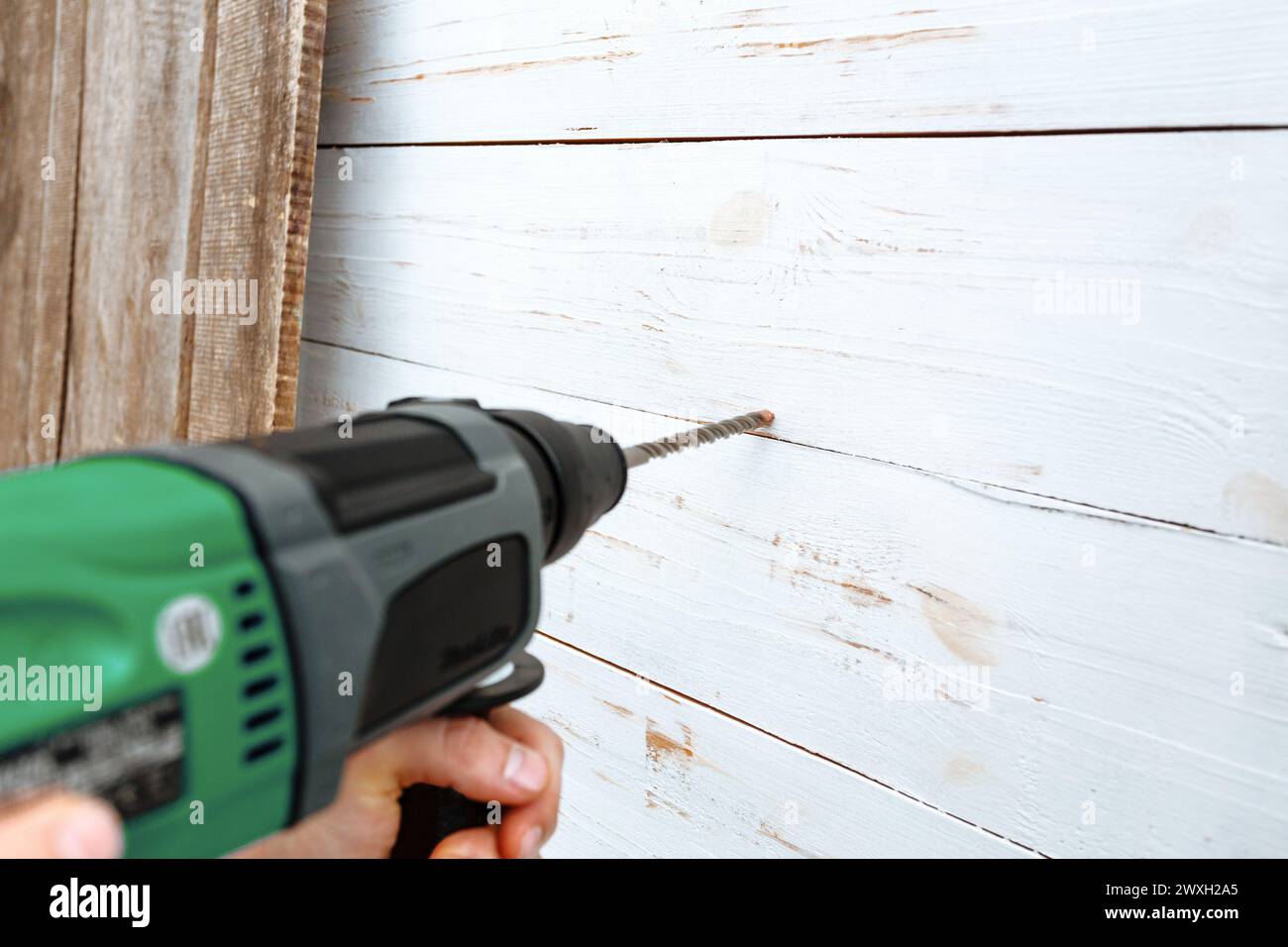 Use hammer drill to drill the wall Stock Photo - Alamy