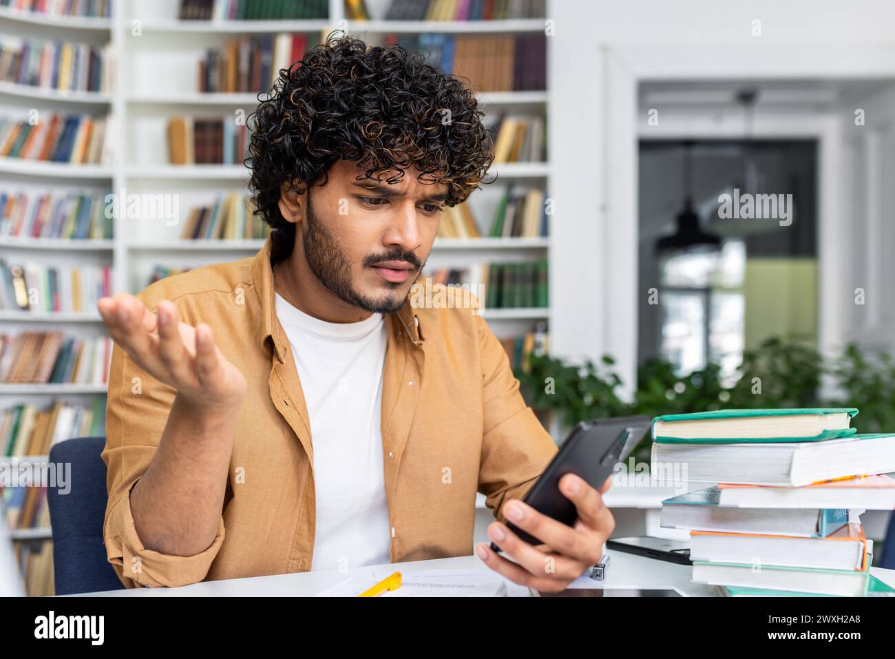 Young man reading book surrounded hi-res stock photography and images ...
