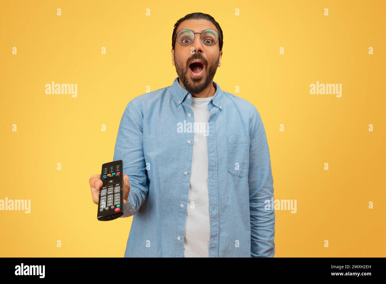 Shocked indian man with a remote control Stock Photo - Alamy