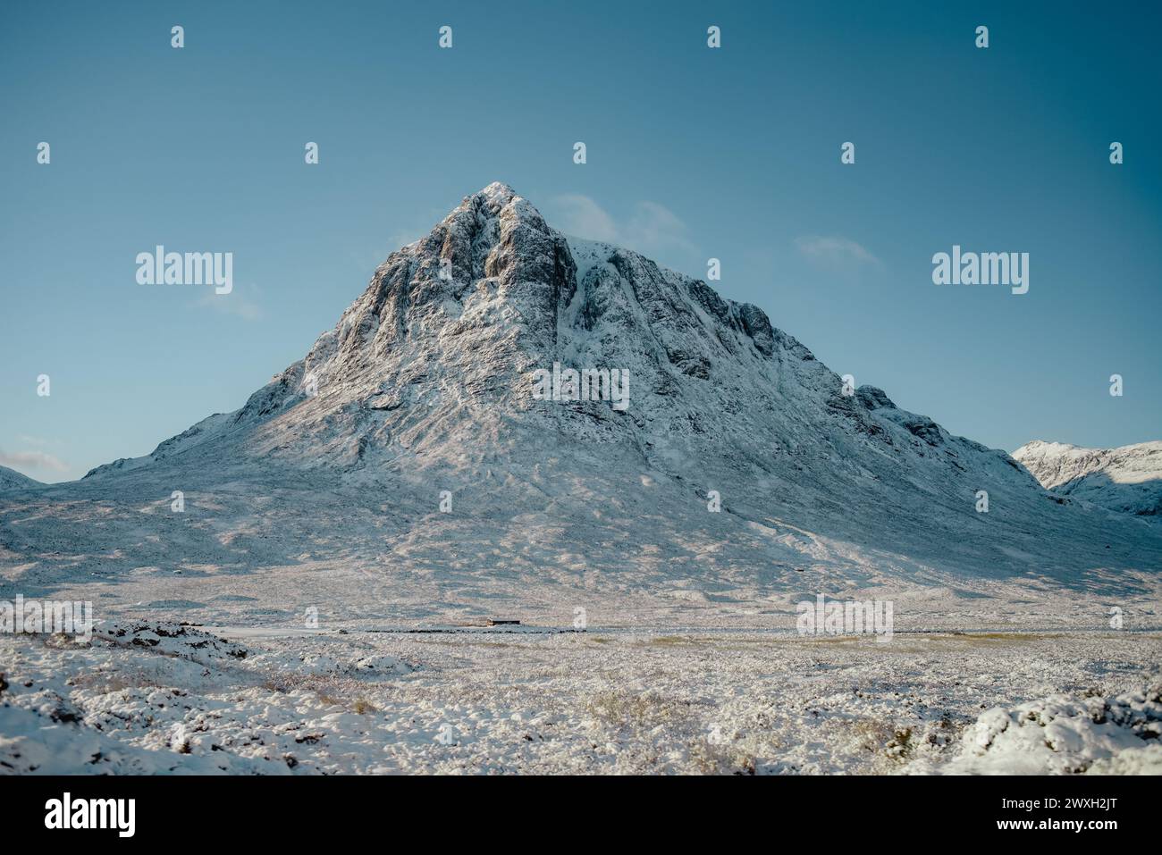 The Buachaille mountain, covered in snow, rising up from Rannoch Moor ...