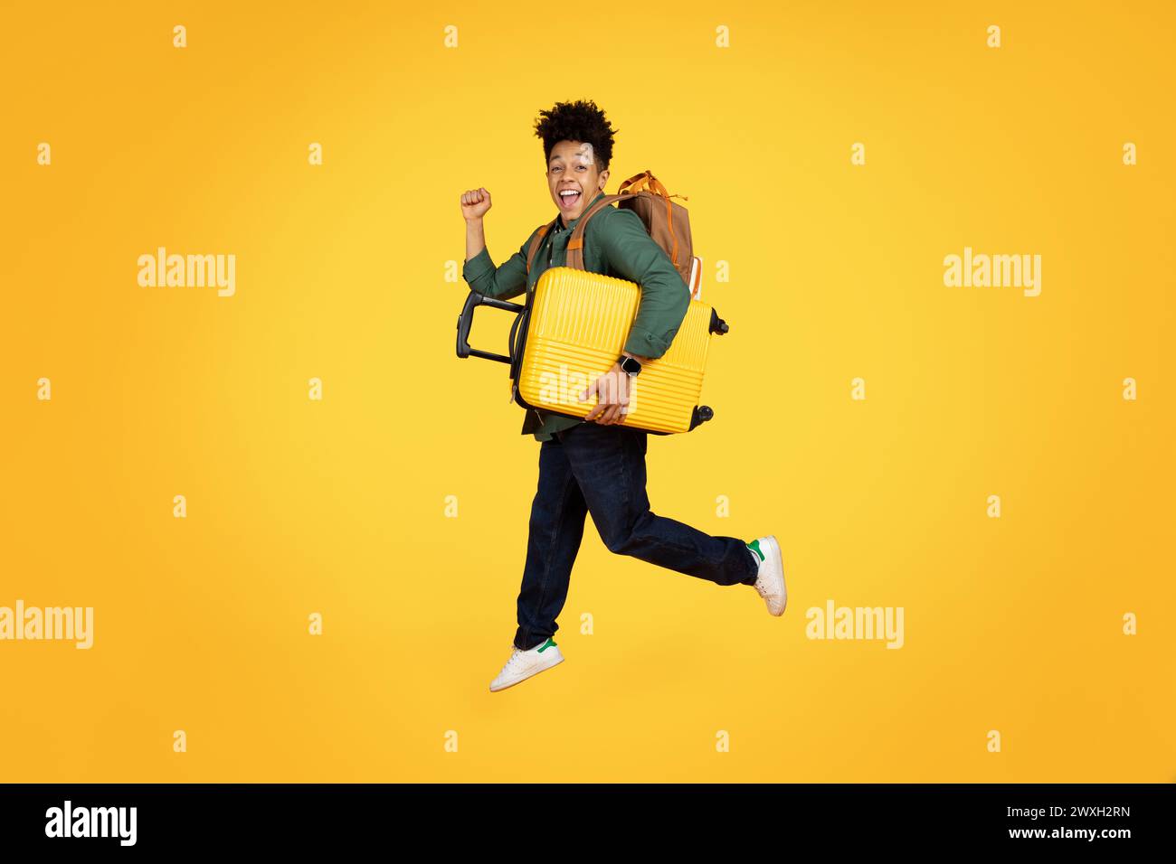 Joyful african american man running with luggage Stock Photo - Alamy