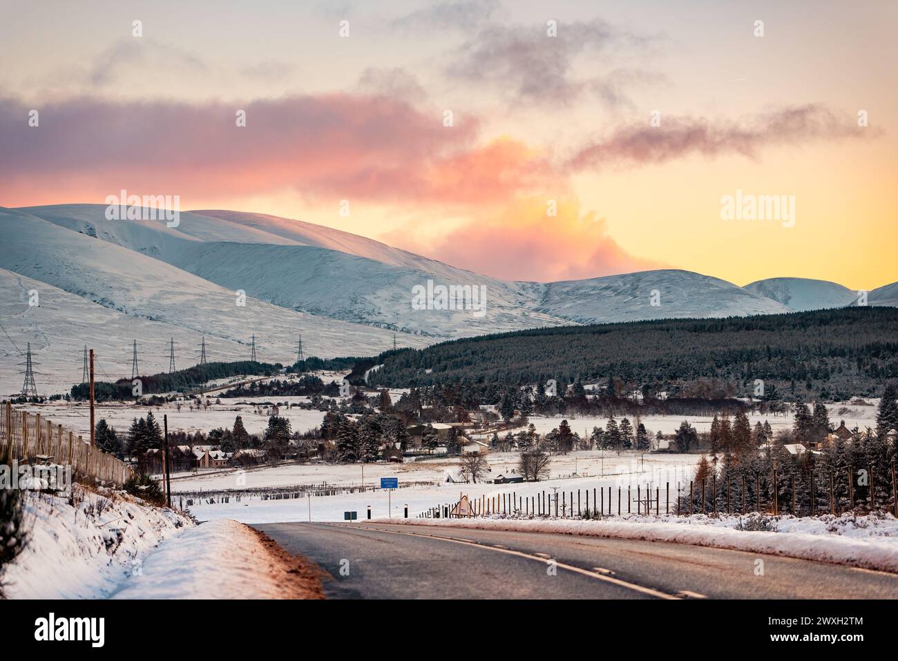 The village of Dalwhinnie in Scotland, against the background of snow ...