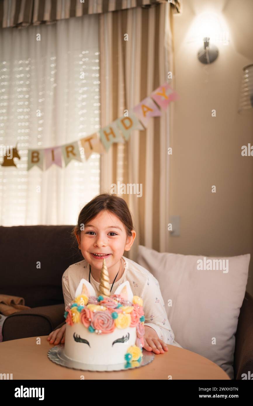 A young girl poses with a gleeful smile beside her magical unicorn ...