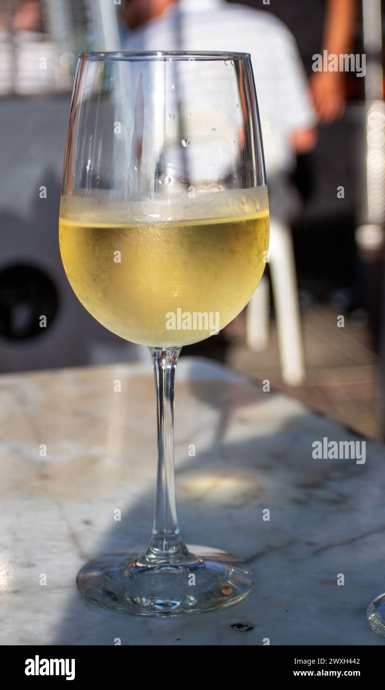 Glass of Cold Wine in an outdoor restaurant Stock Photo - Alamy