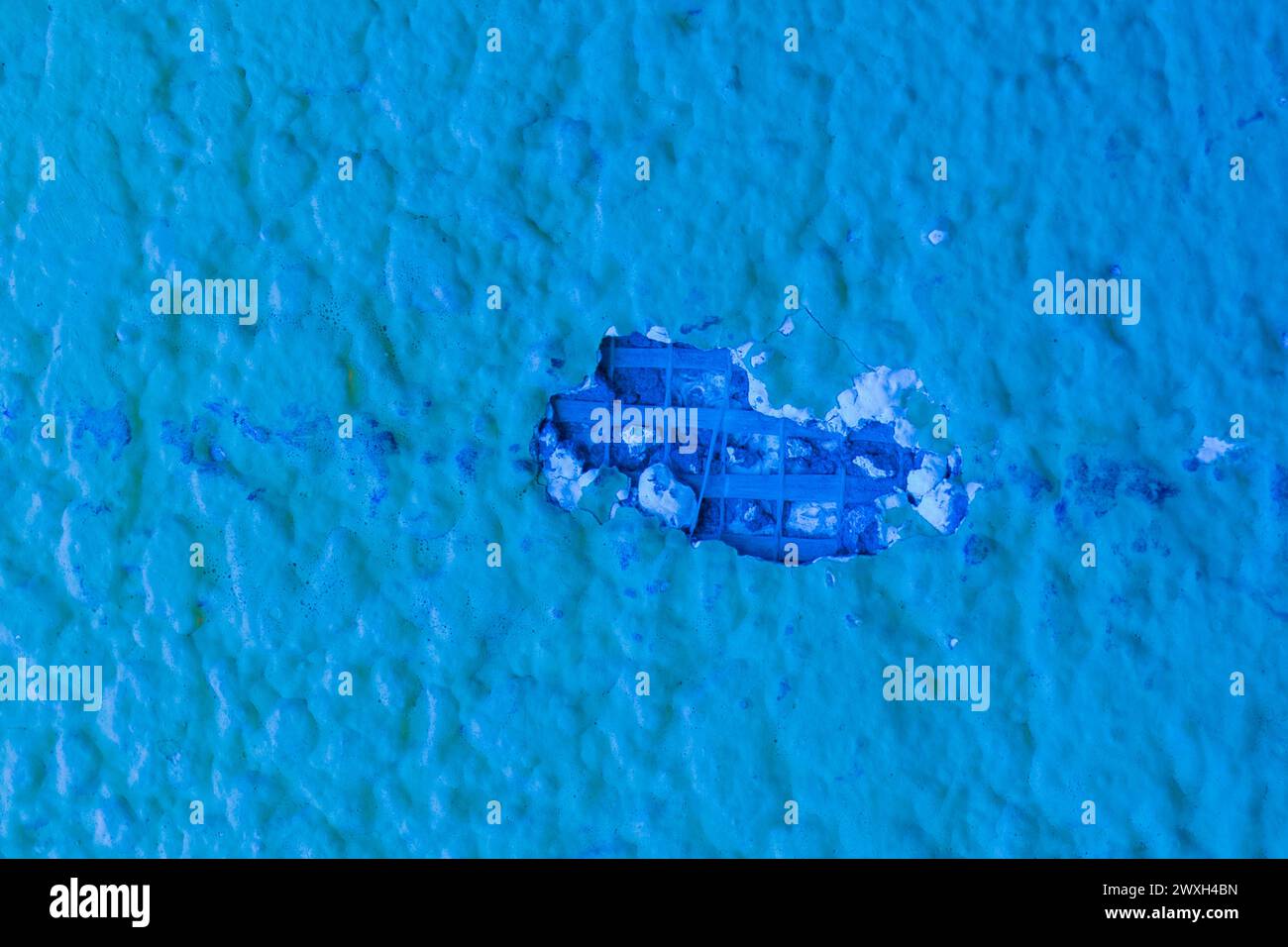 Hole wall close-up ruined broken damaged construction texture blue ...