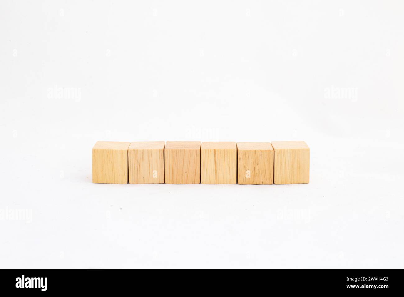 Six blank wooden blocks in a row on a white background with blank space ...