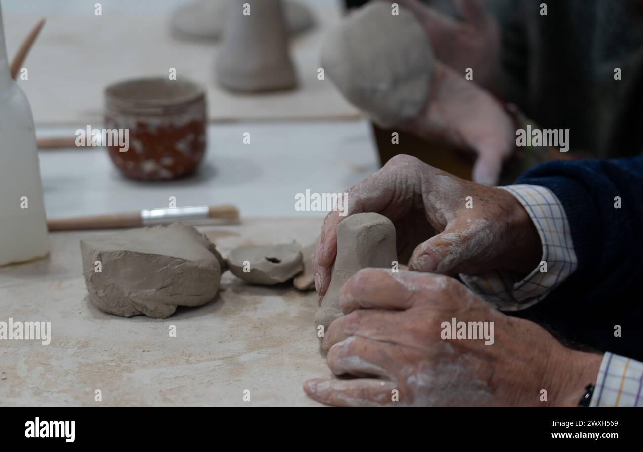 Hands of senior man learning pottery in a pottery class Stock Photo - Alamy