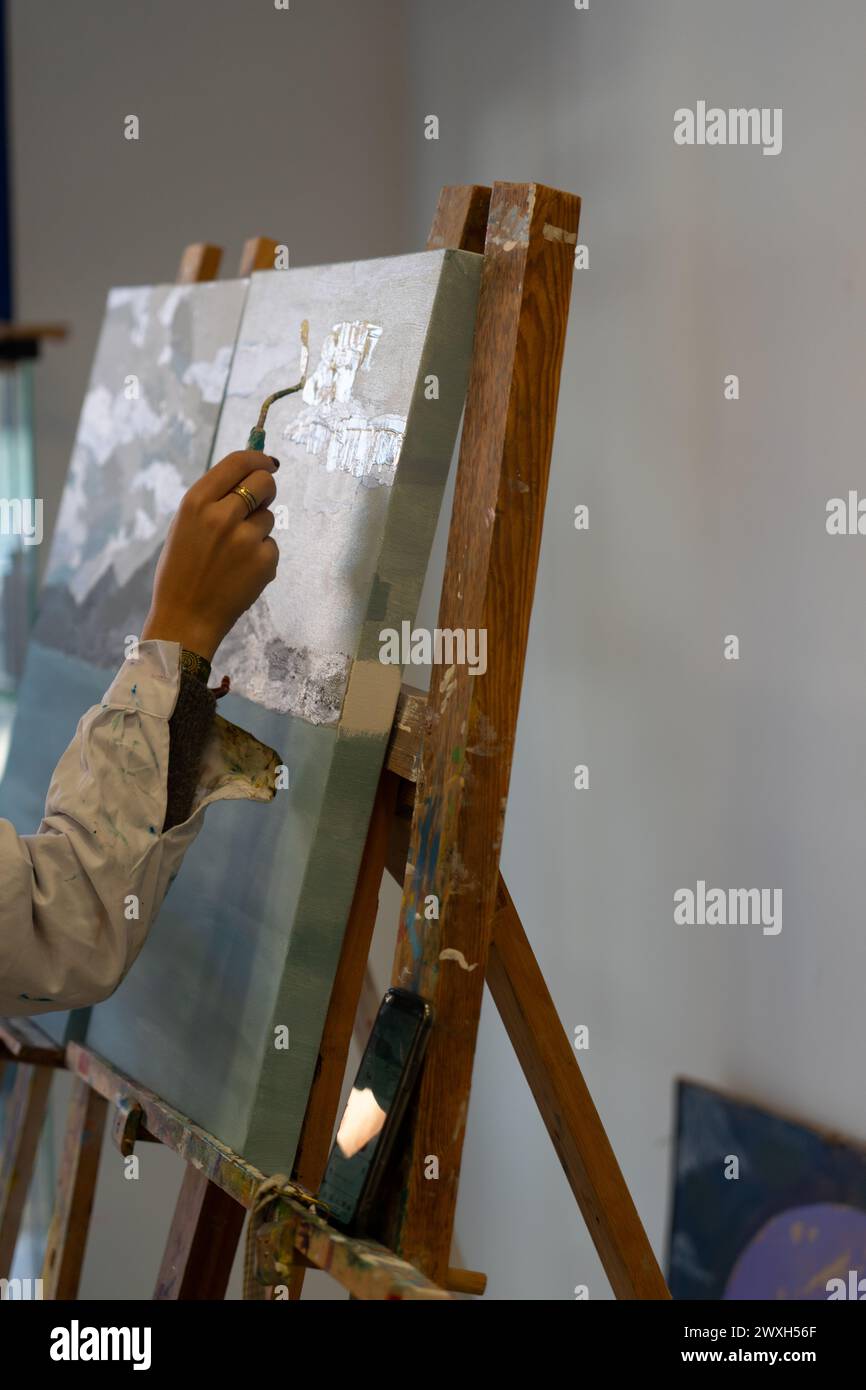 Woman's hand painting on a canvas in a painting workshop Stock Photo ...
