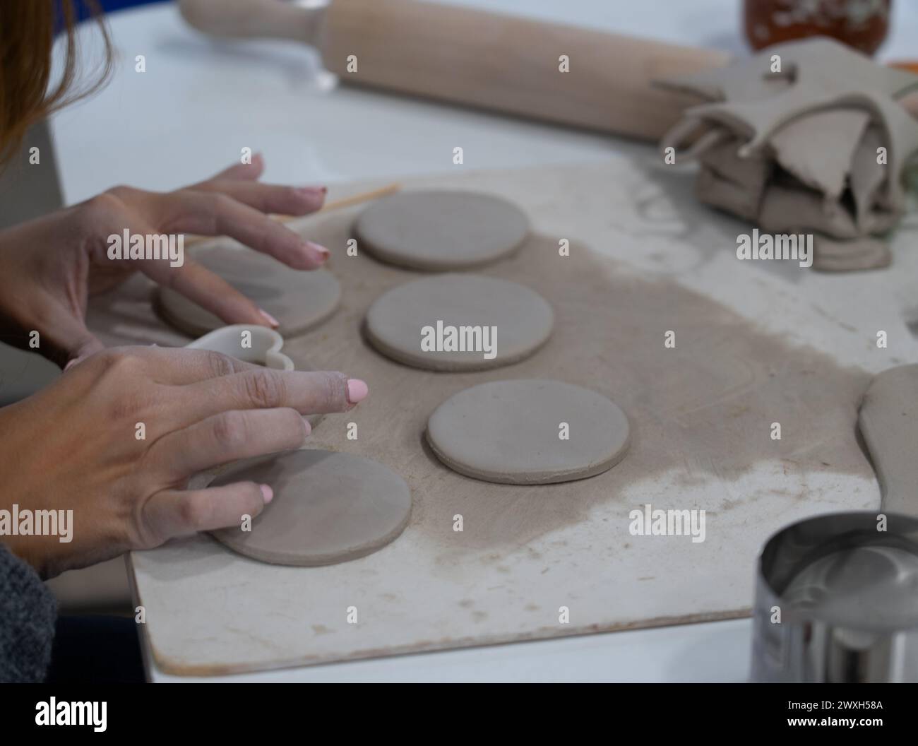 Woman's hands making pottery in a workshop Stock Photo - Alamy