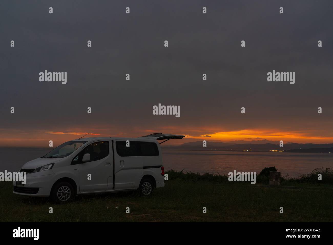 Camper van at sunset in nature Stock Photo - Alamy