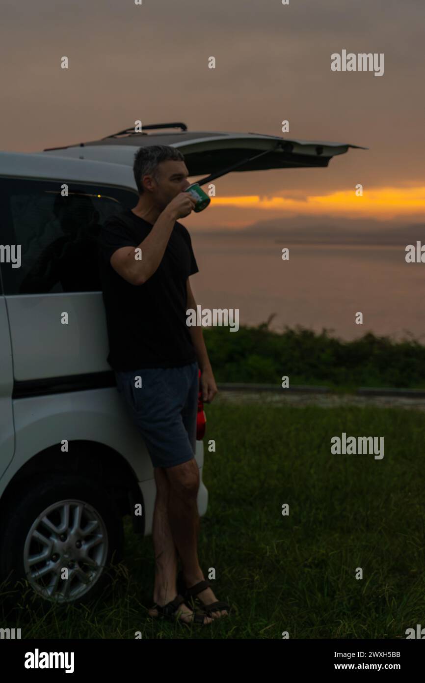 Man traveling in camper van drinking coffee at dawn Stock Photo - Alamy