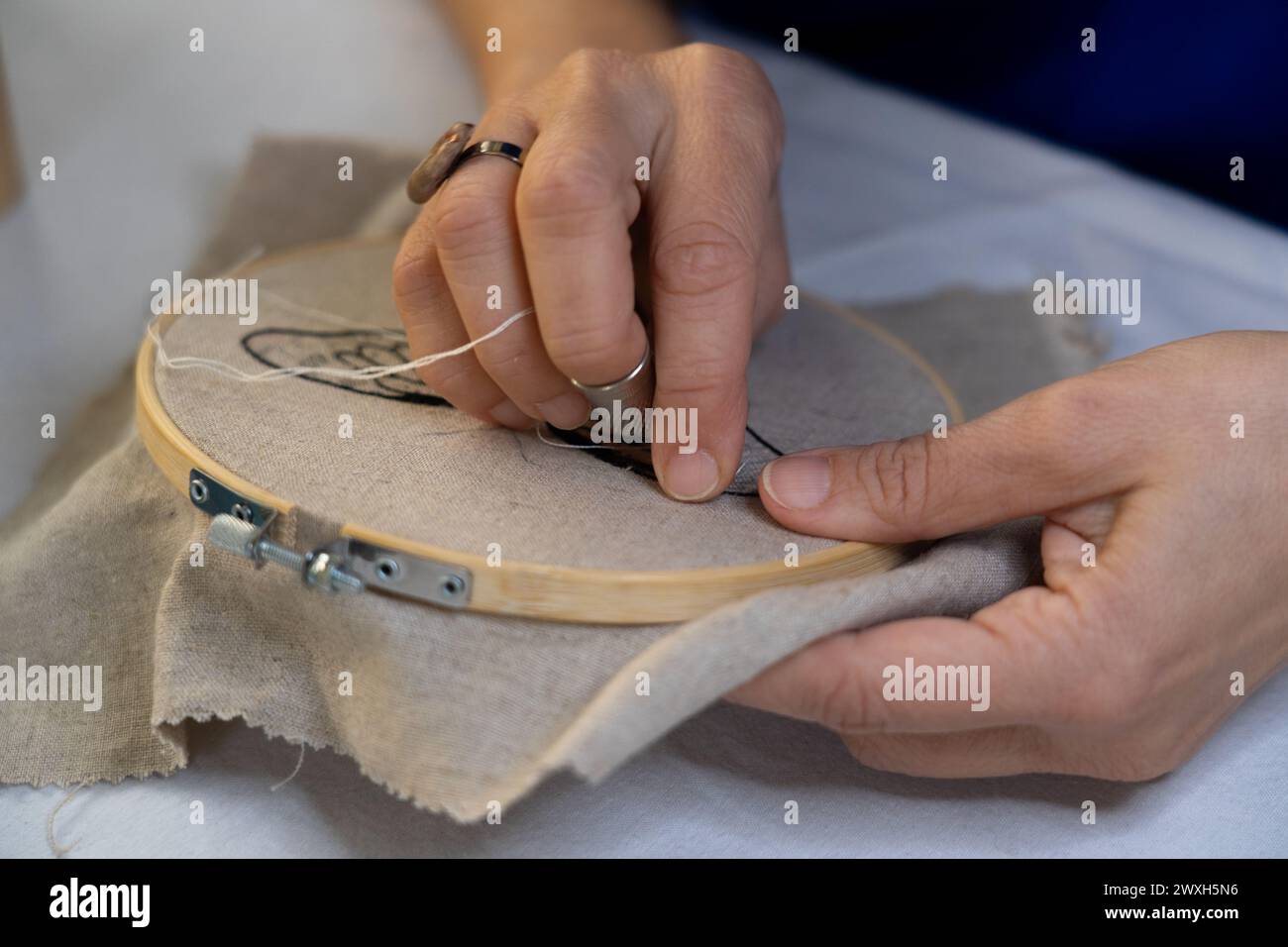 Hands of women embroidering by hand Stock Photo - Alamy