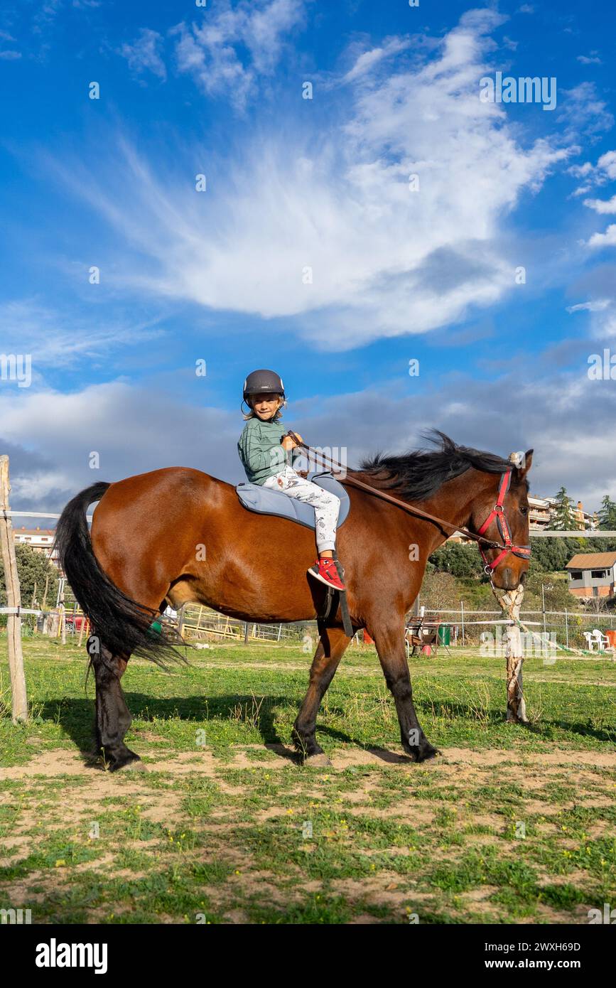 Blond boy riding a horse Stock Photo - Alamy