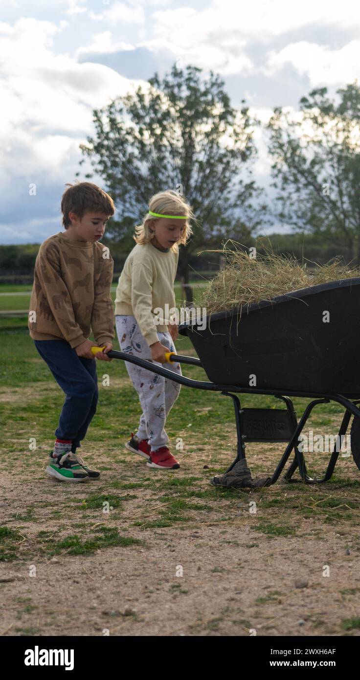 Kids in wheelbarrow on hi-res stock photography and images - Alamy