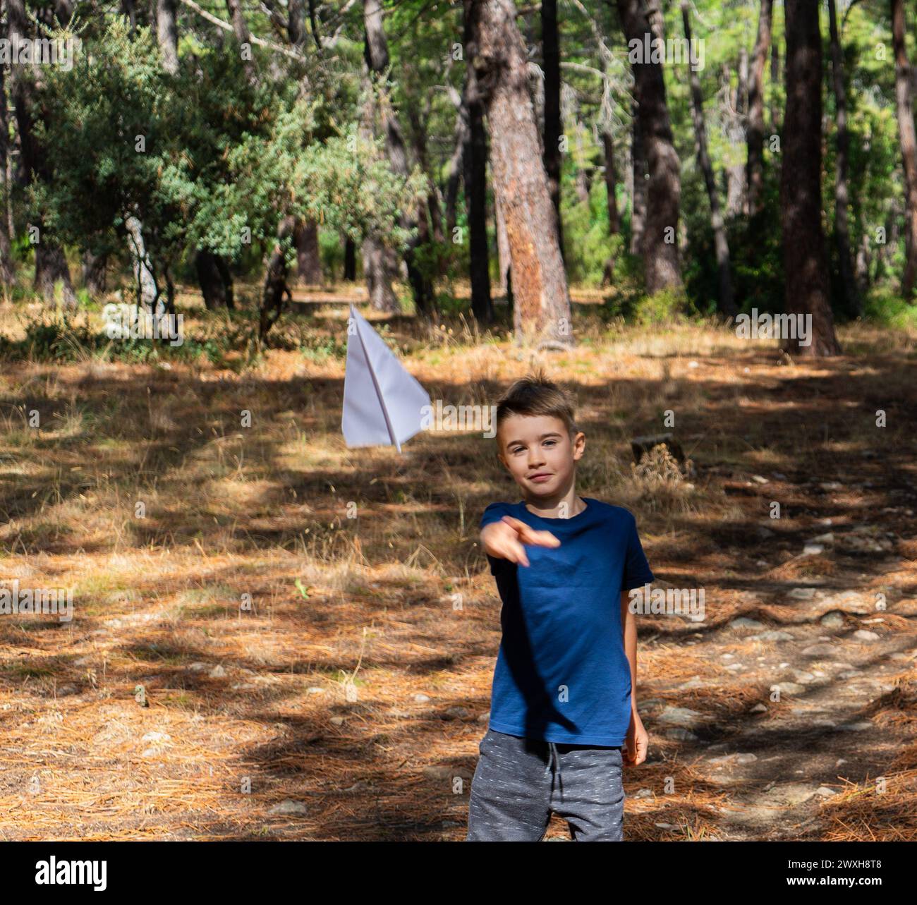 8-year-old boy launching a paper airplane into the wild Stock Photo - Alamy