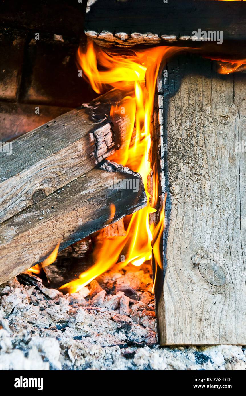 Flames, charcoal, and wood burning in a brick fire pit Stock Photo - Alamy