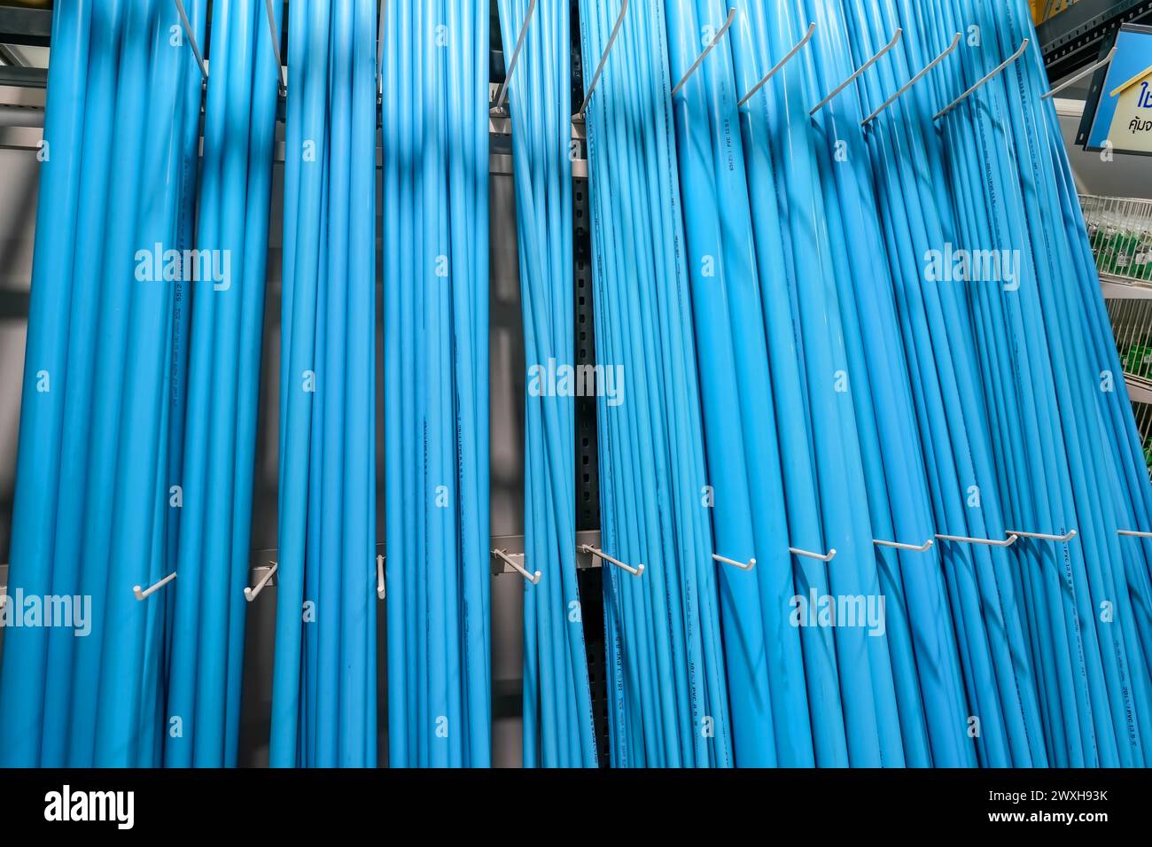 Various blue plastic pipes on the counter in a store Stock Photo - Alamy