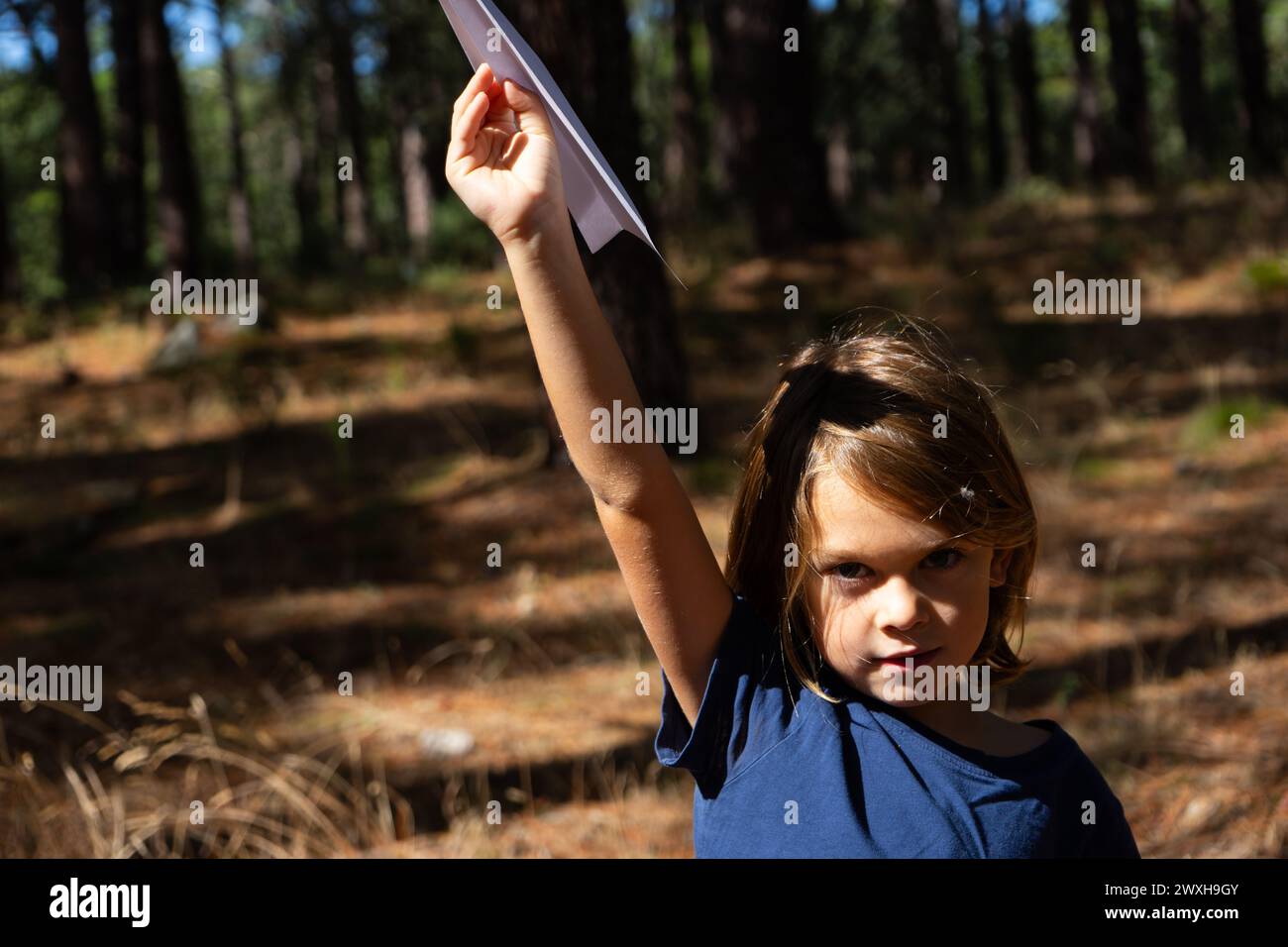 Boy with a paper airplane in his hand in nature Stock Photo - Alamy