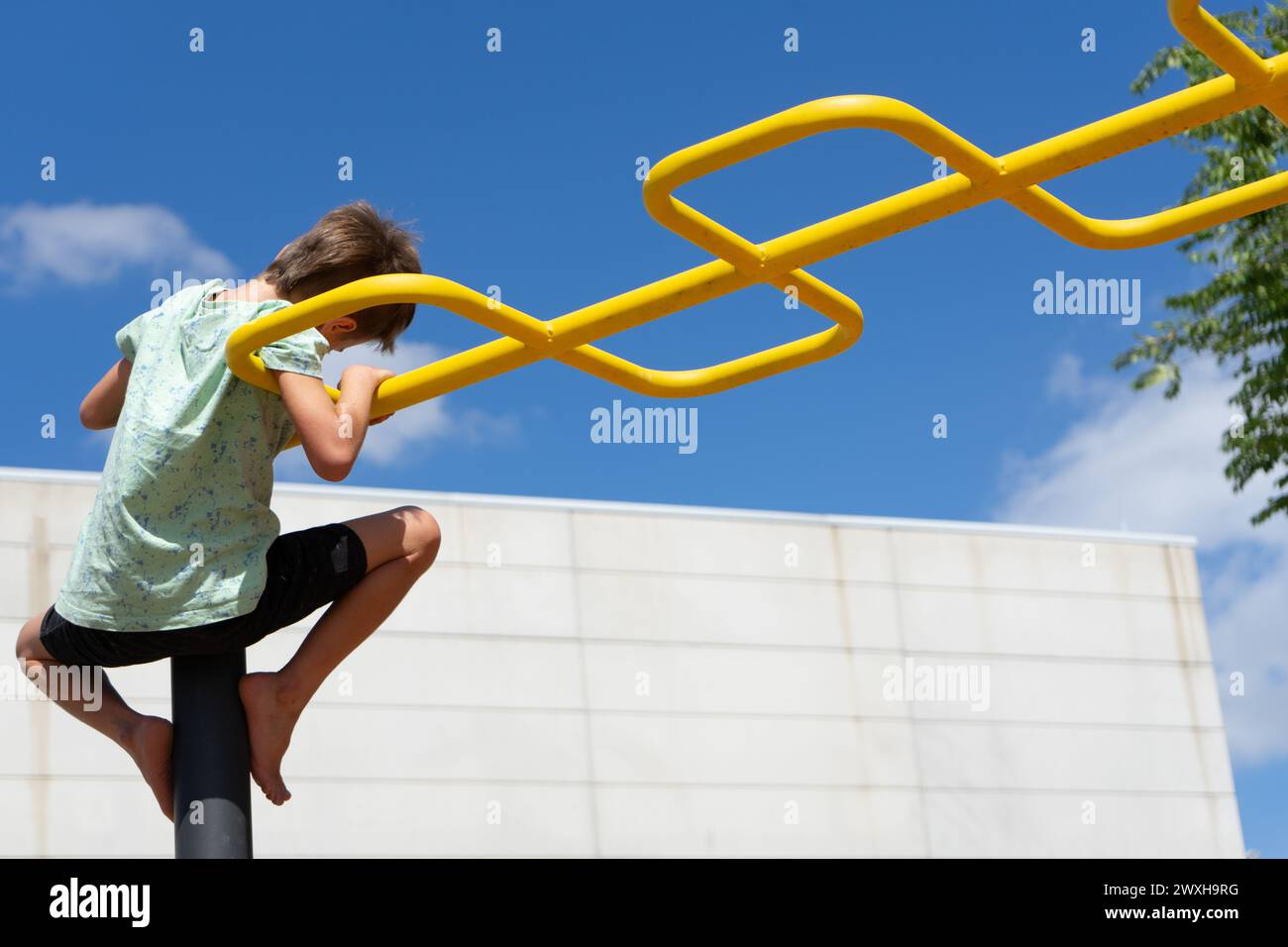 Child climbing a playground structure Stock Photo - Alamy