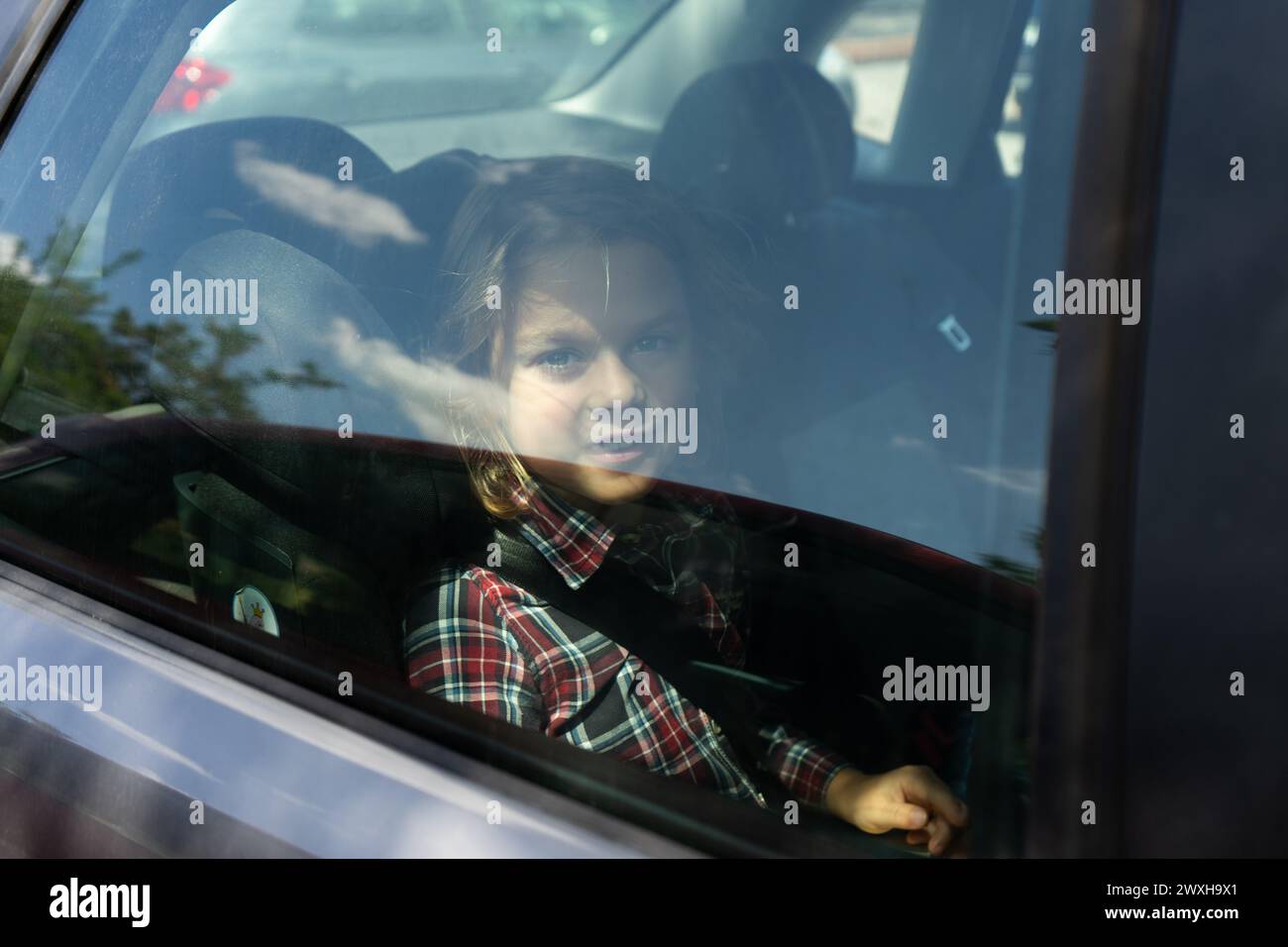 Child inside the car seen from outside through the window Stock Photo ...