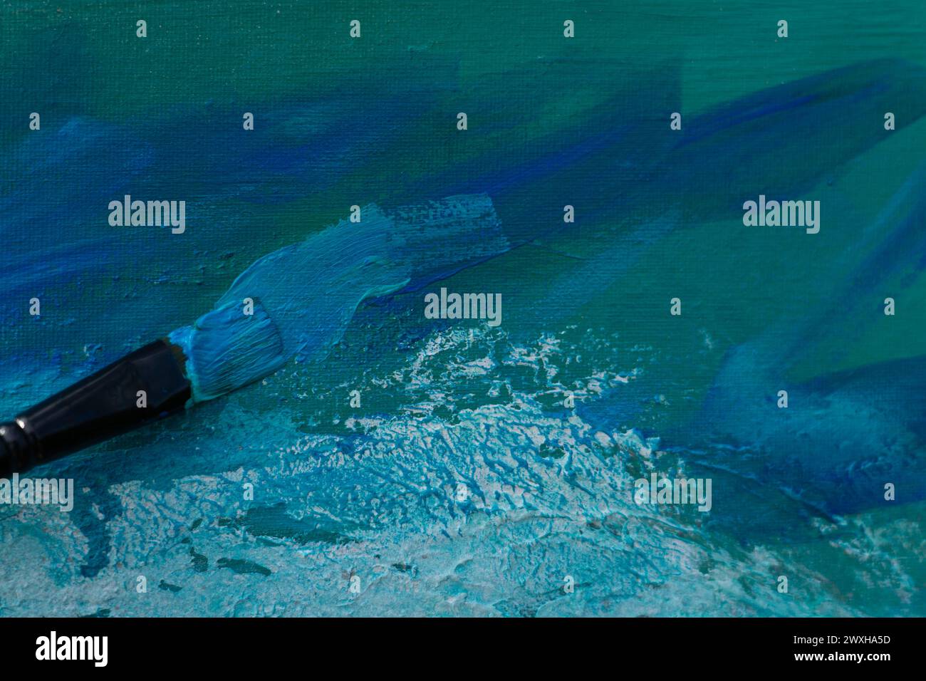 Brush seen from up close painting with acrylic paint a canvas of ...