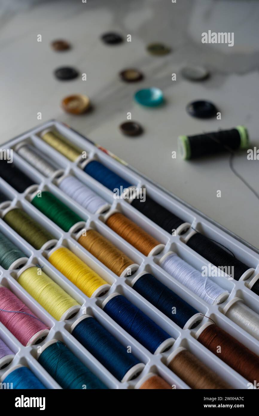 Set of coils of sewing threads and buttons Stock Photo - Alamy