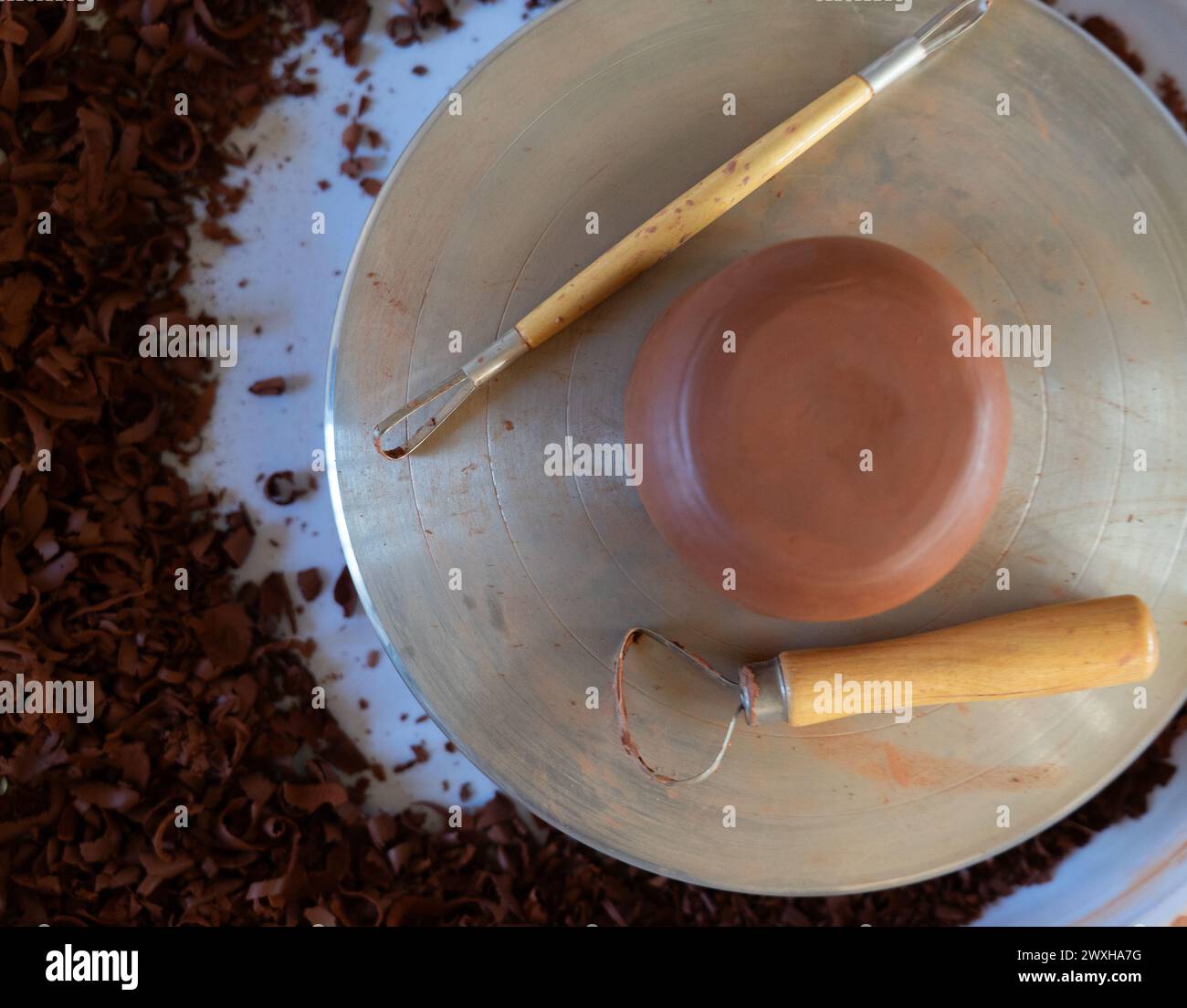Potter's wheel with a piece of pottery on top and pottery tools Stock ...