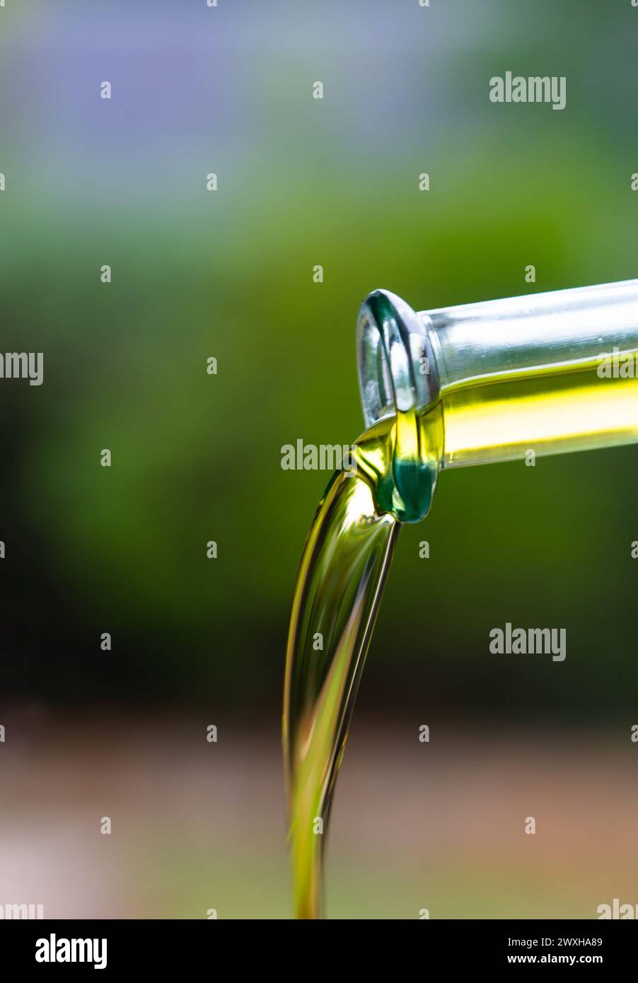 Extra virgin olive oil falling closely Stock Photo - Alamy
