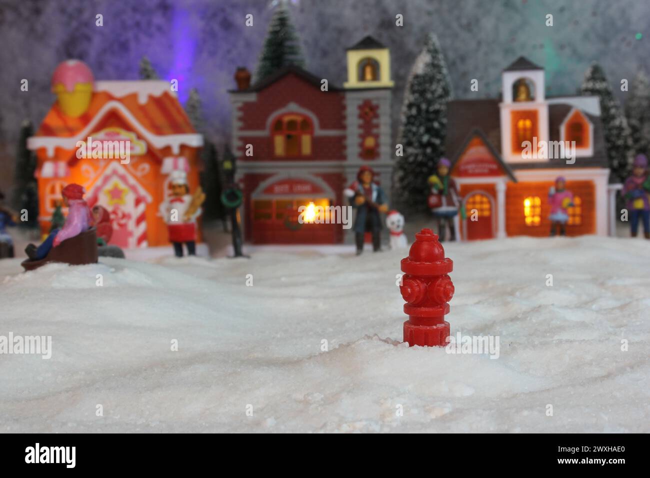 Snow-covered small town with red fire hydrant Stock Photo - Alamy