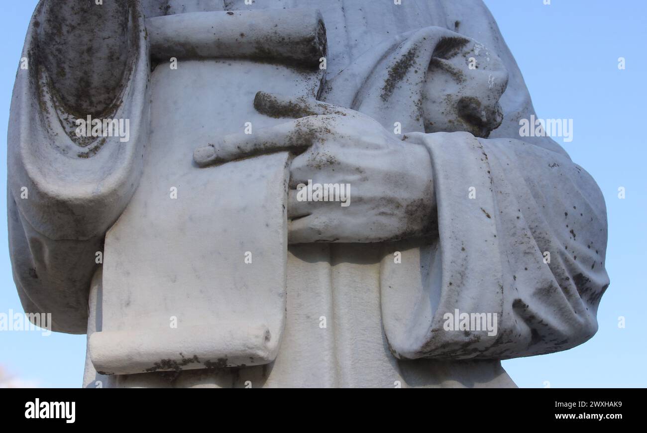 Statue of Jesus cradling a cat against a sky backdrop Stock Photo - Alamy