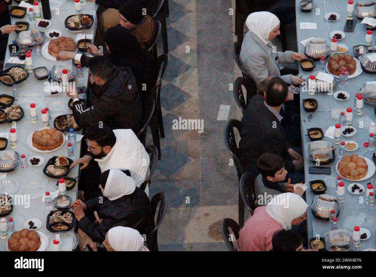 Aleppo, Syria. 30th Mar, 2024. People attend an iftar banquet at the ...